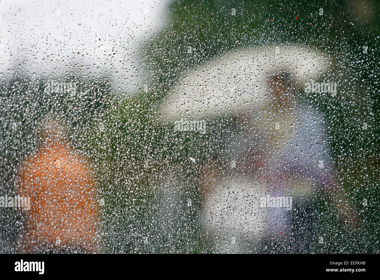Rain on a window looking out to people in a street scene Stock Photo ...