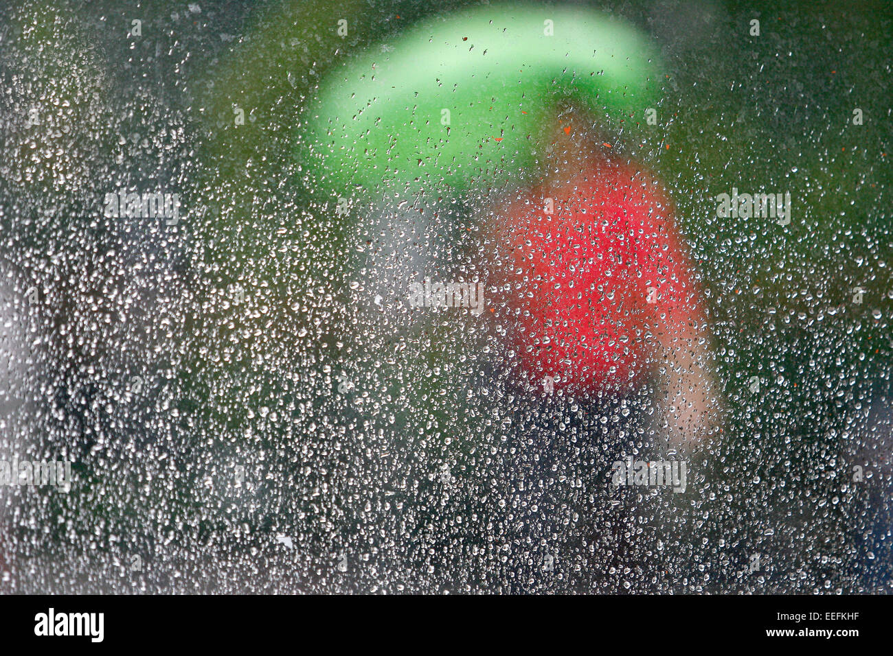 Rain on a window looking out to people in a street scene Stock Photo ...