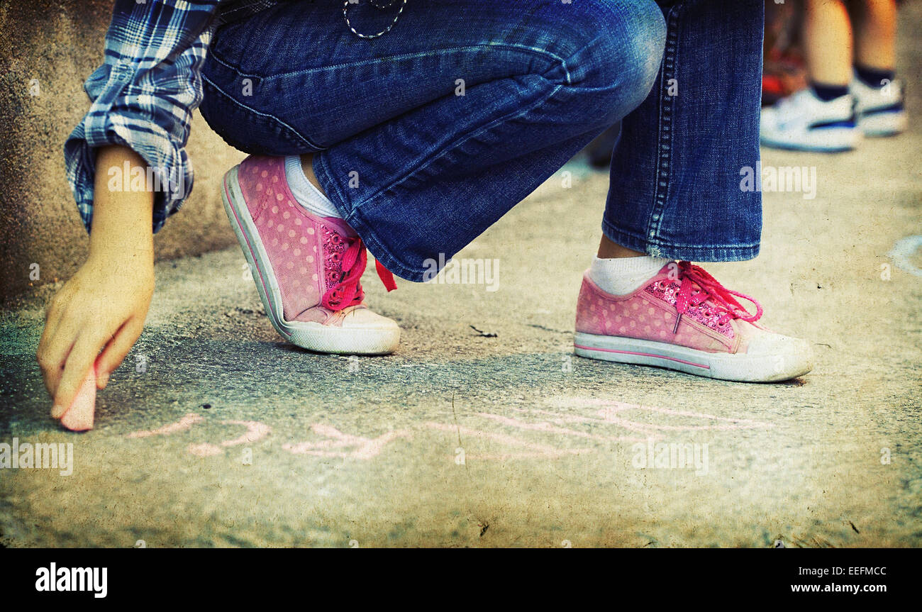 Vintage photo of little girl in jeans writing with chalk on the ...
