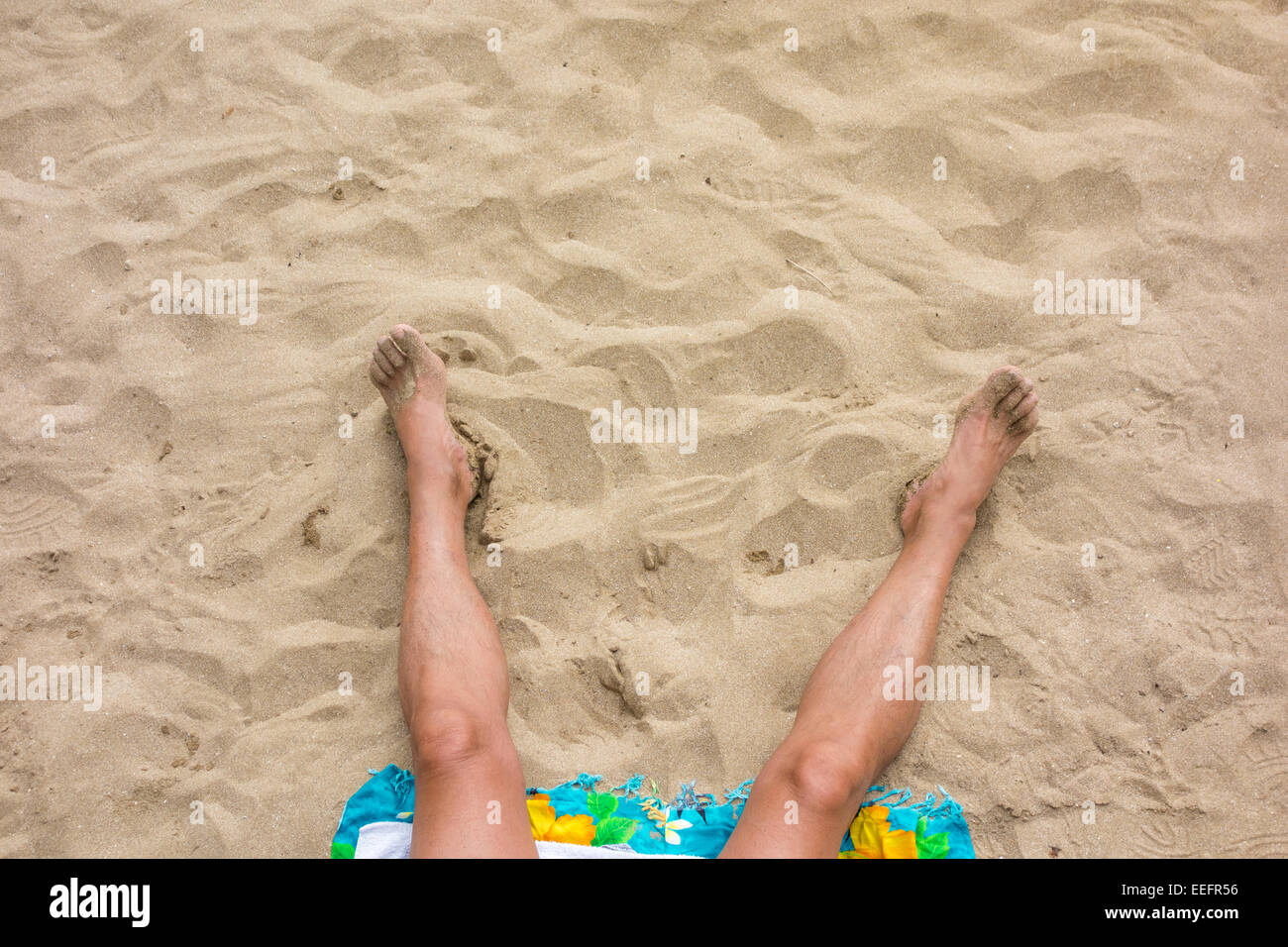 Man sunbathing on beach in Spain Stock Photo - Alamy
