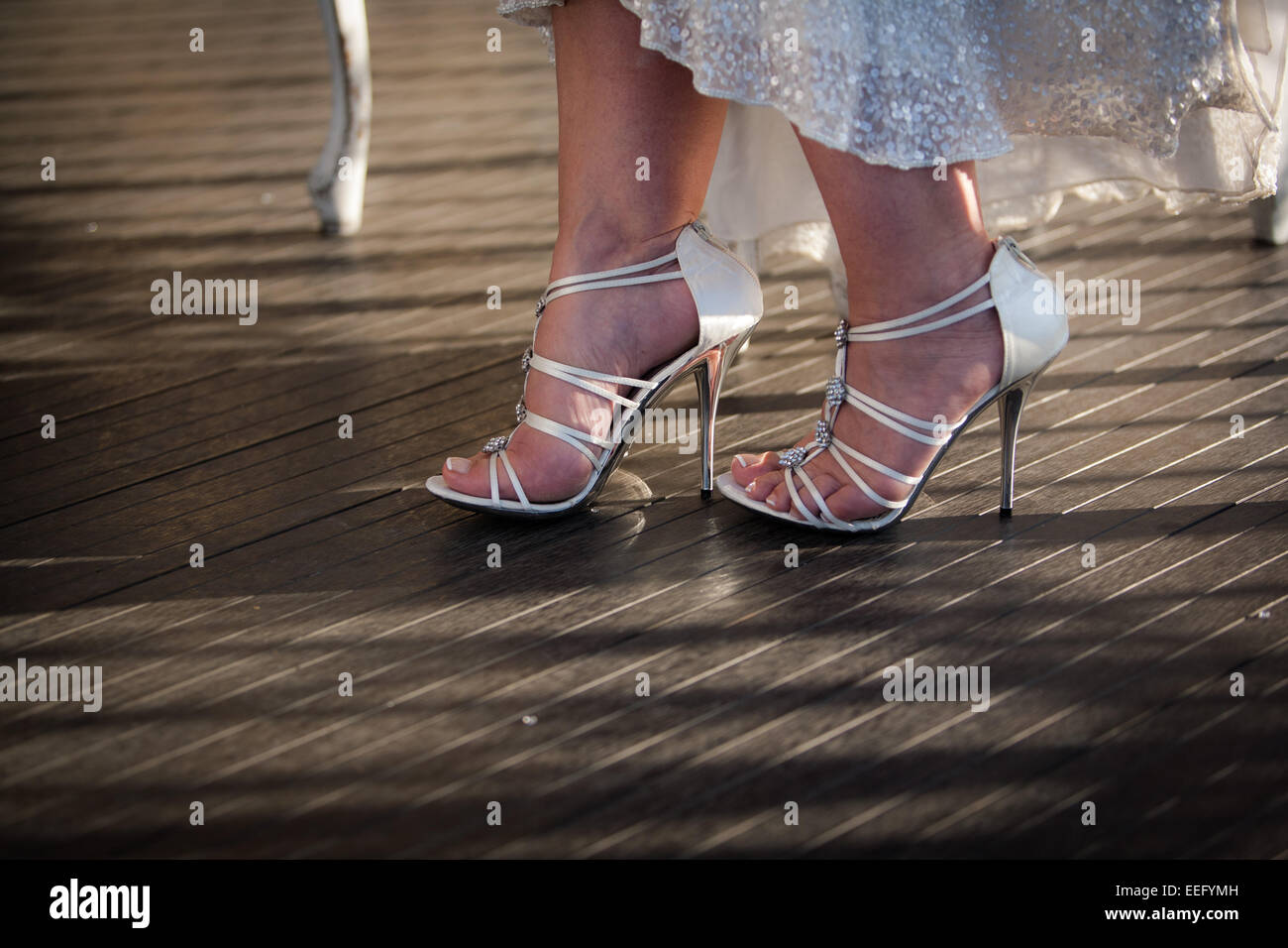lower section of bride standing on a wooden floor Stock Photo - Alamy