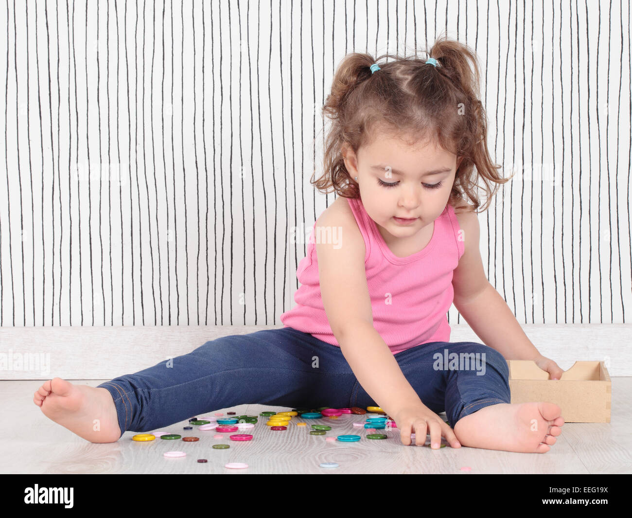 happy girl playing with some buttons Stock Photo - Alamy