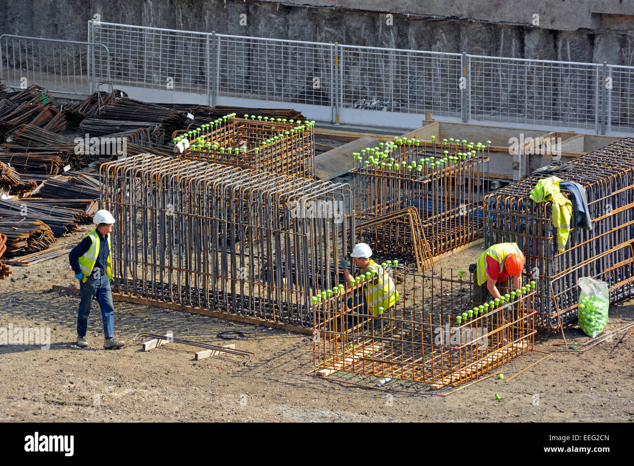 Yellow safety caps on projecting steel bars & steel fixers ...