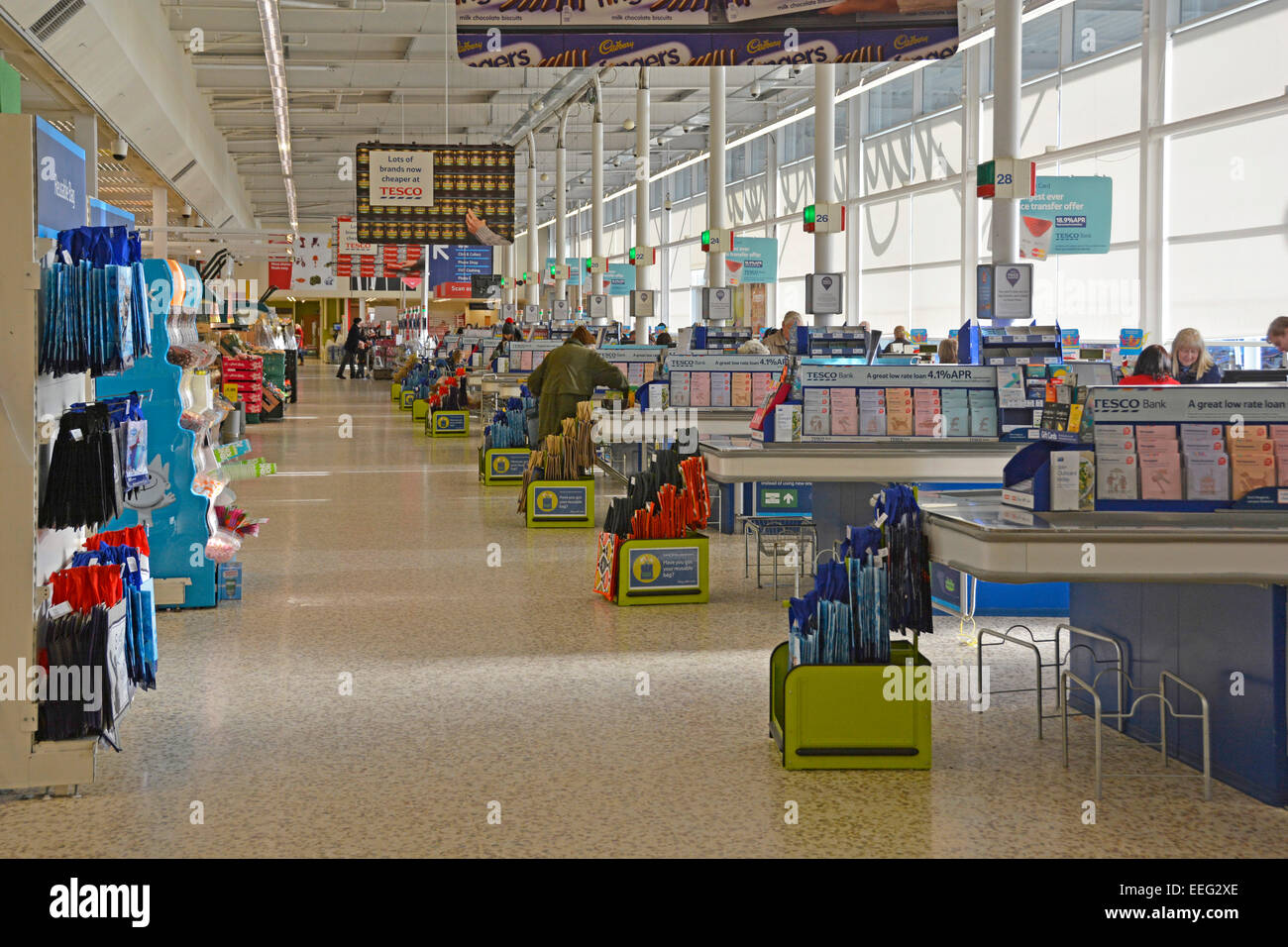 Tesco Extra supermarket store interior view of long aisle of check out ...