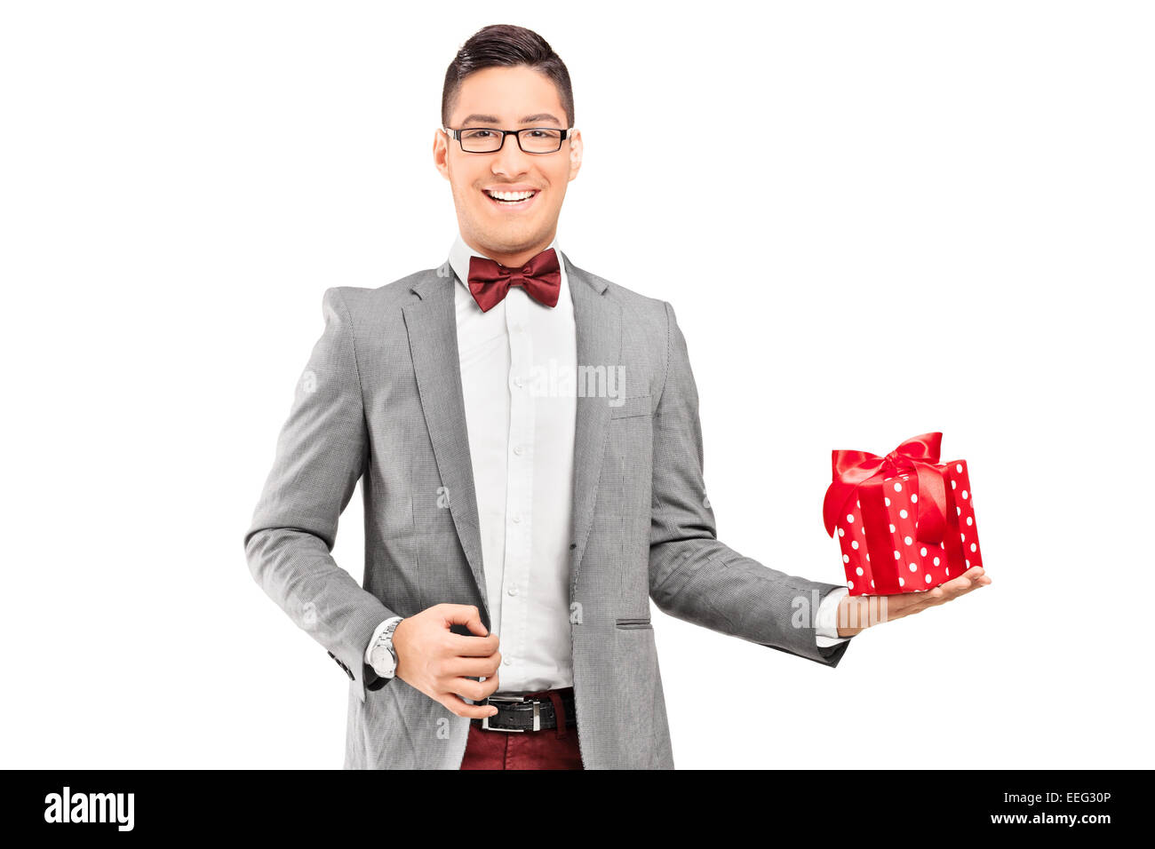 Elegant man holding a present isolated against white background Stock ...