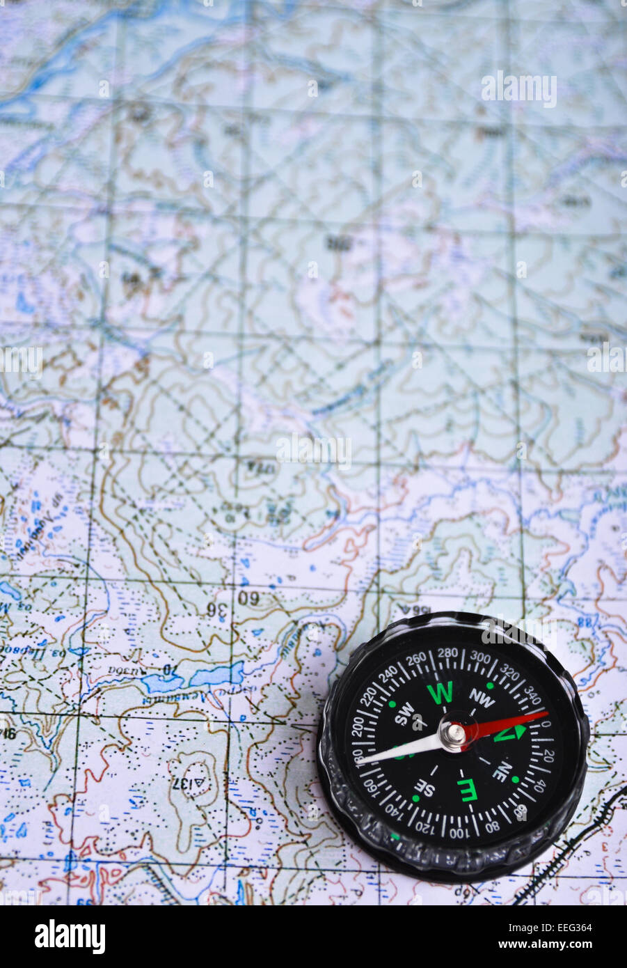 The magnetic compass is located on a topographic map. Equipment for ...