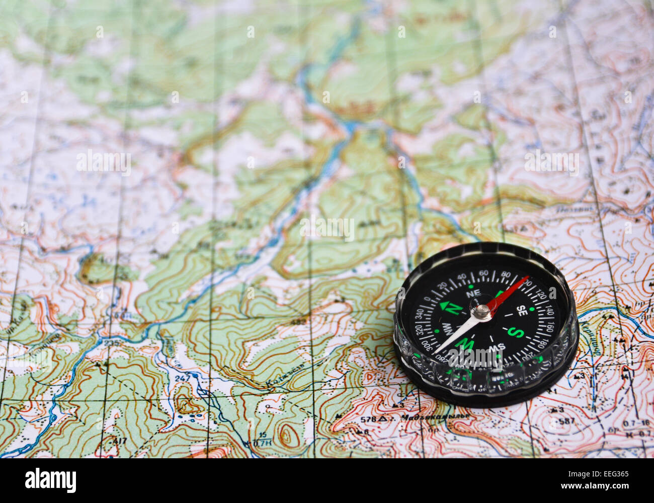 The magnetic compass is located on a topographic map. Satellites ...