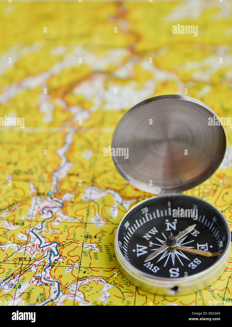 The magnetic compass is located on a topographic map. Satellites ...