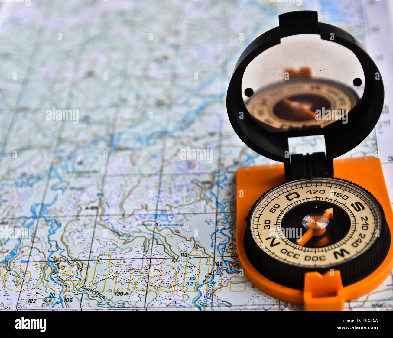 The magnetic compass is located on a topographic map. Equipment for ...