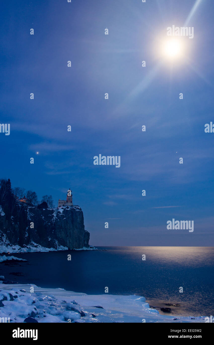 Split Rock Lighthouse glows under the moon on the shore of Lake ...