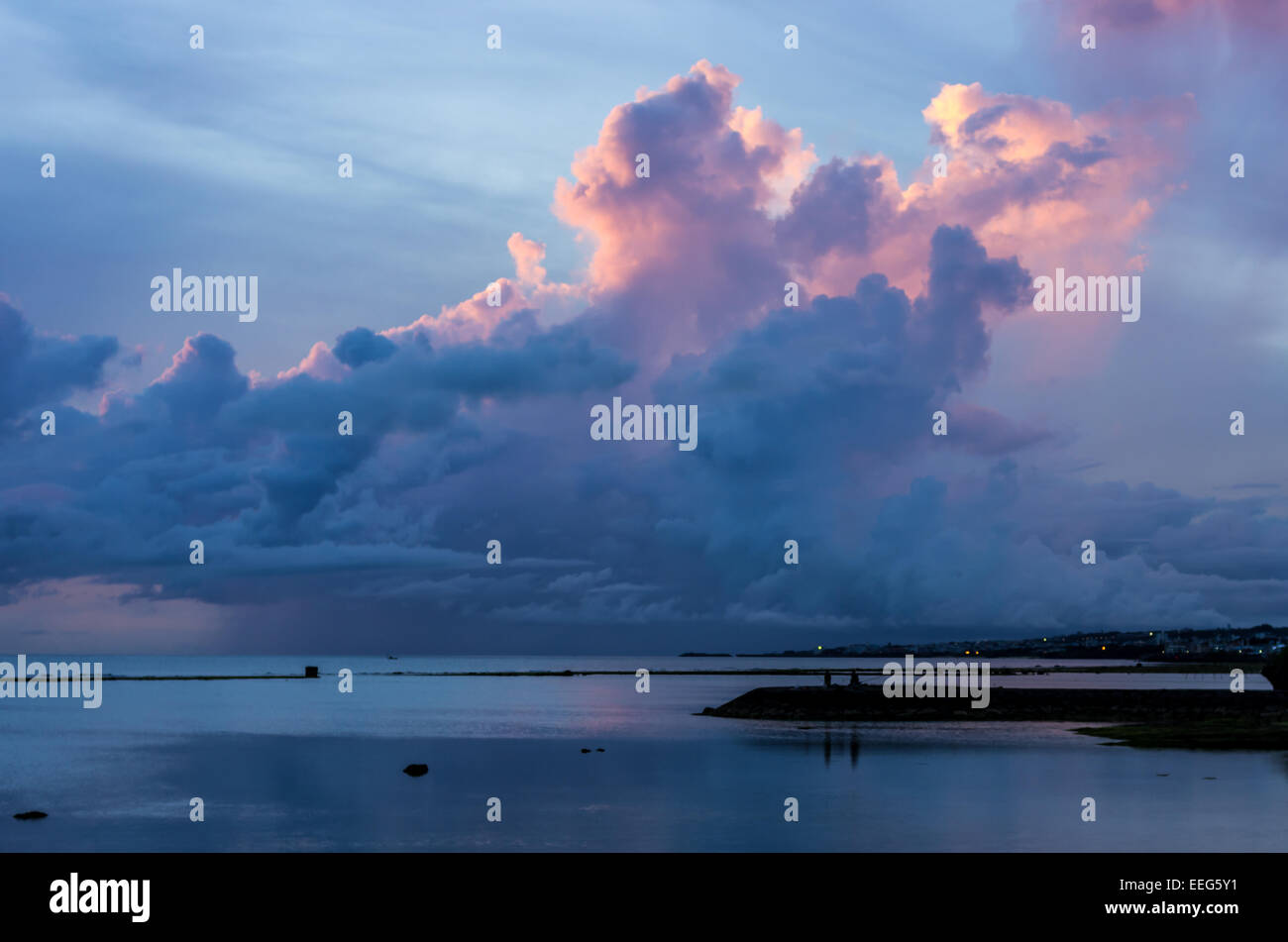 Fishermen pause to watch the sunset at Sunabe Beach in Okinawa, Japan ...