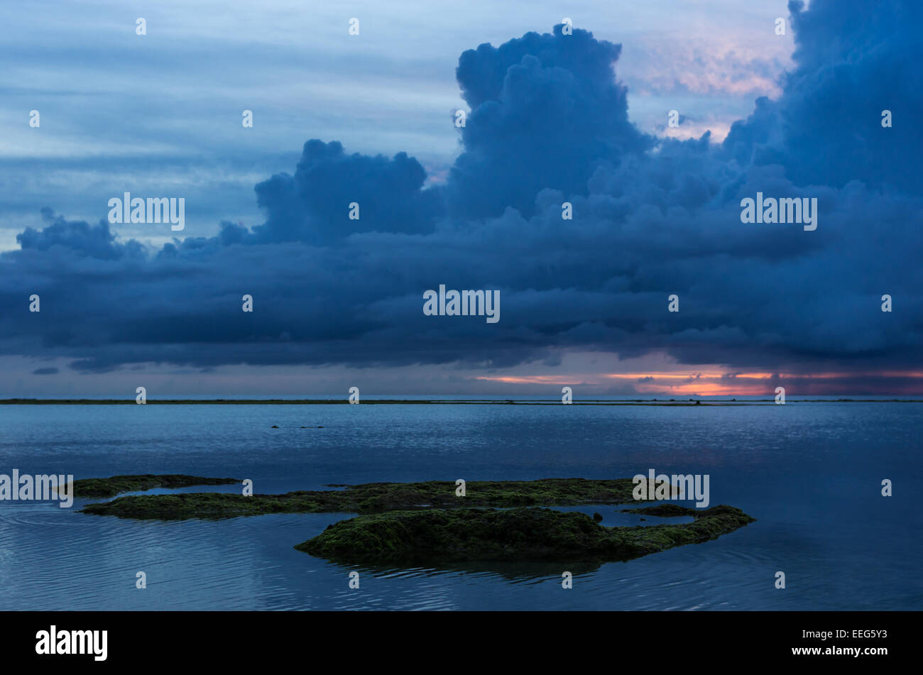 Little islands form at low tide in this sunset scene at Sunabe Beach in ...