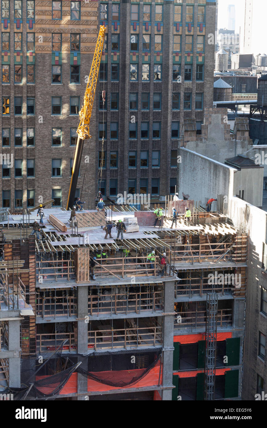 High-rise Building Construction Site, NYC with tradesmen Stock Photo ...