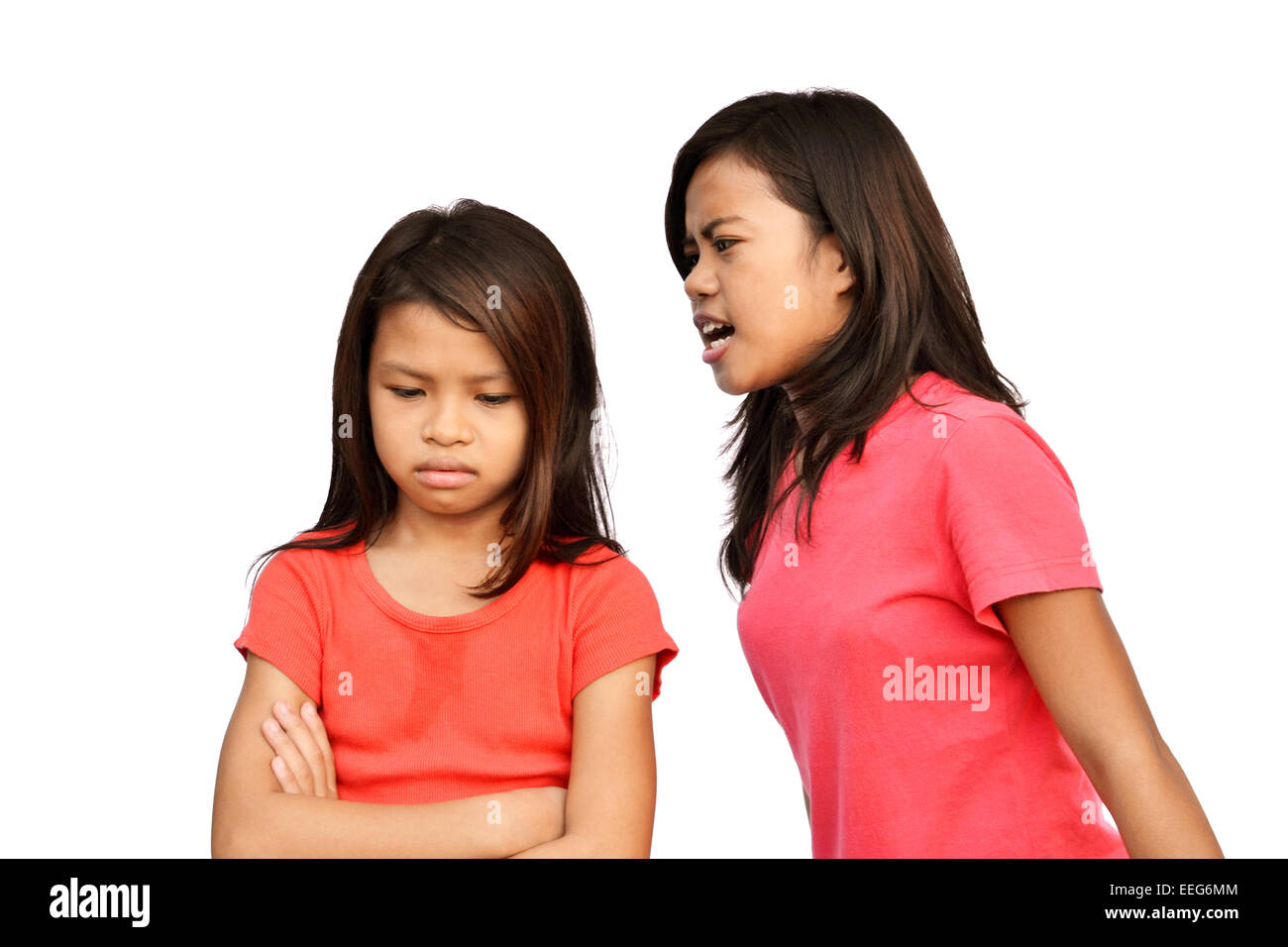 Asian teen shouting on her younger sister Stock Photo - Alamy
