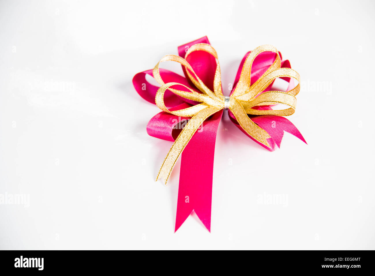 Pink ribbon with bow isolated on white Stock Photo - Alamy