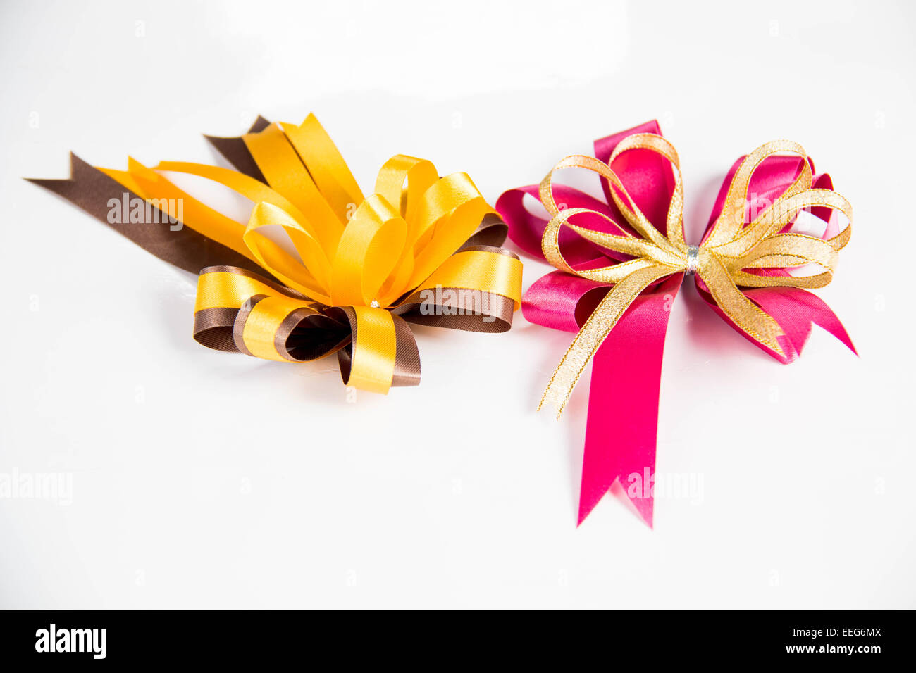 Pink and yellow ribbon with bow isolated on white Stock Photo - Alamy
