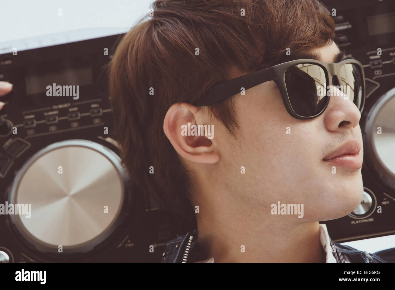 Handsome asian guy with turntables dj mixer Stock Photo - Alamy