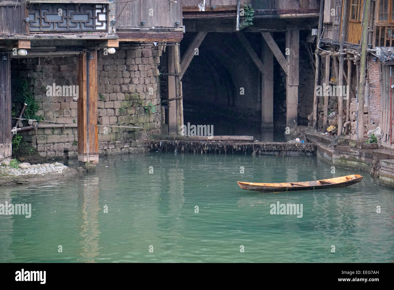 Wooden boat on the river , tide by old structure, traditional building ...