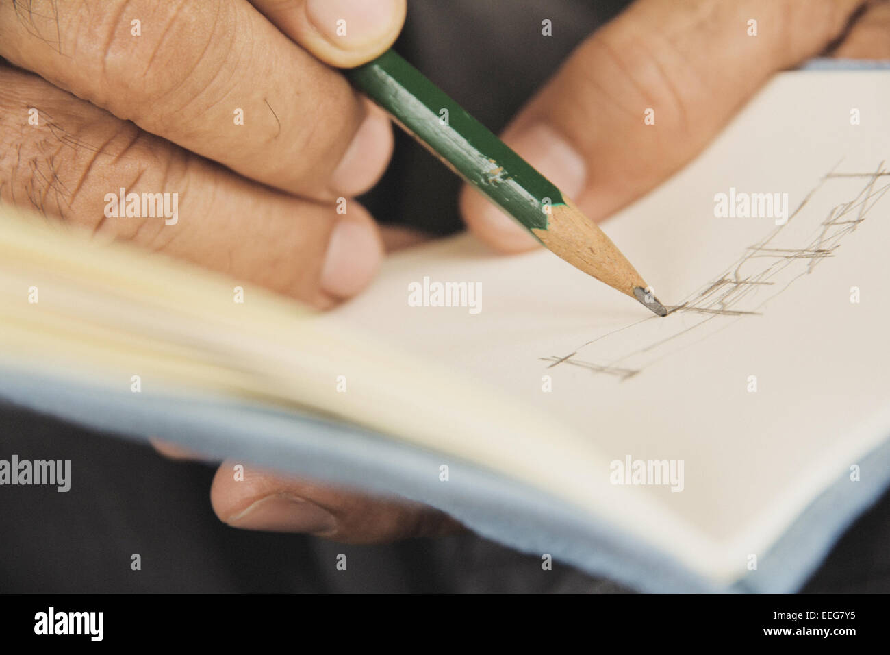 man writing on sketchbook Stock Photo - Alamy