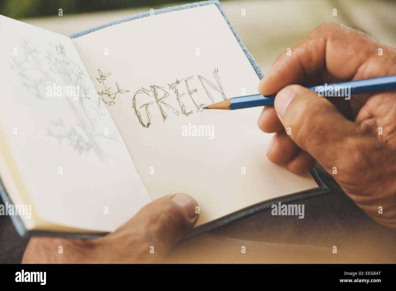 man writing on sketchbook Stock Photo - Alamy