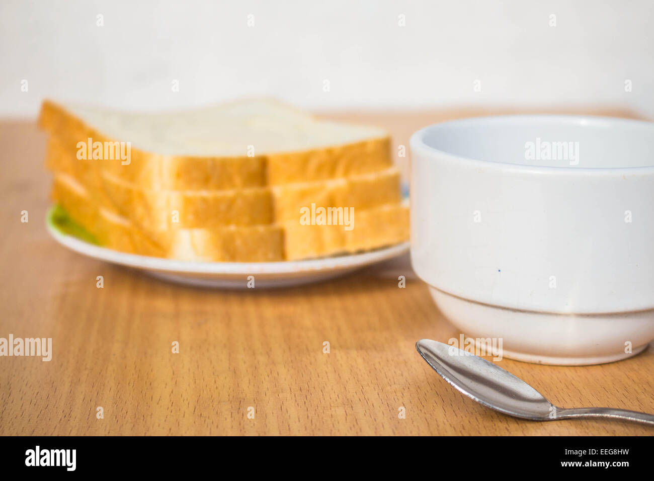 Cup of coffee and bread on the table Stock Photo - Alamy