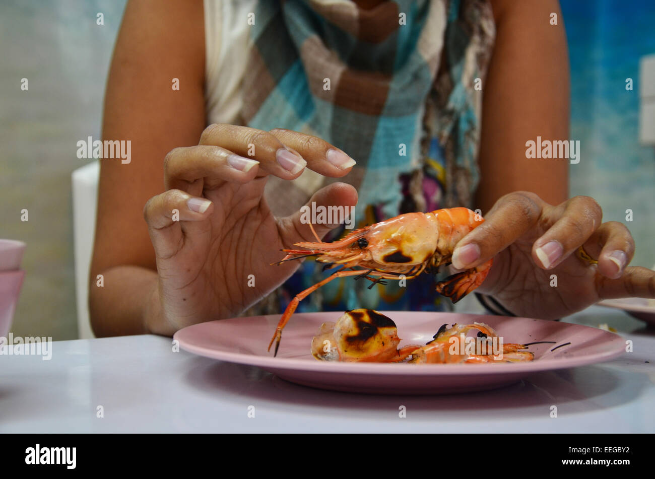Woman peeling shrimp hi-res stock photography and images - Alamy
