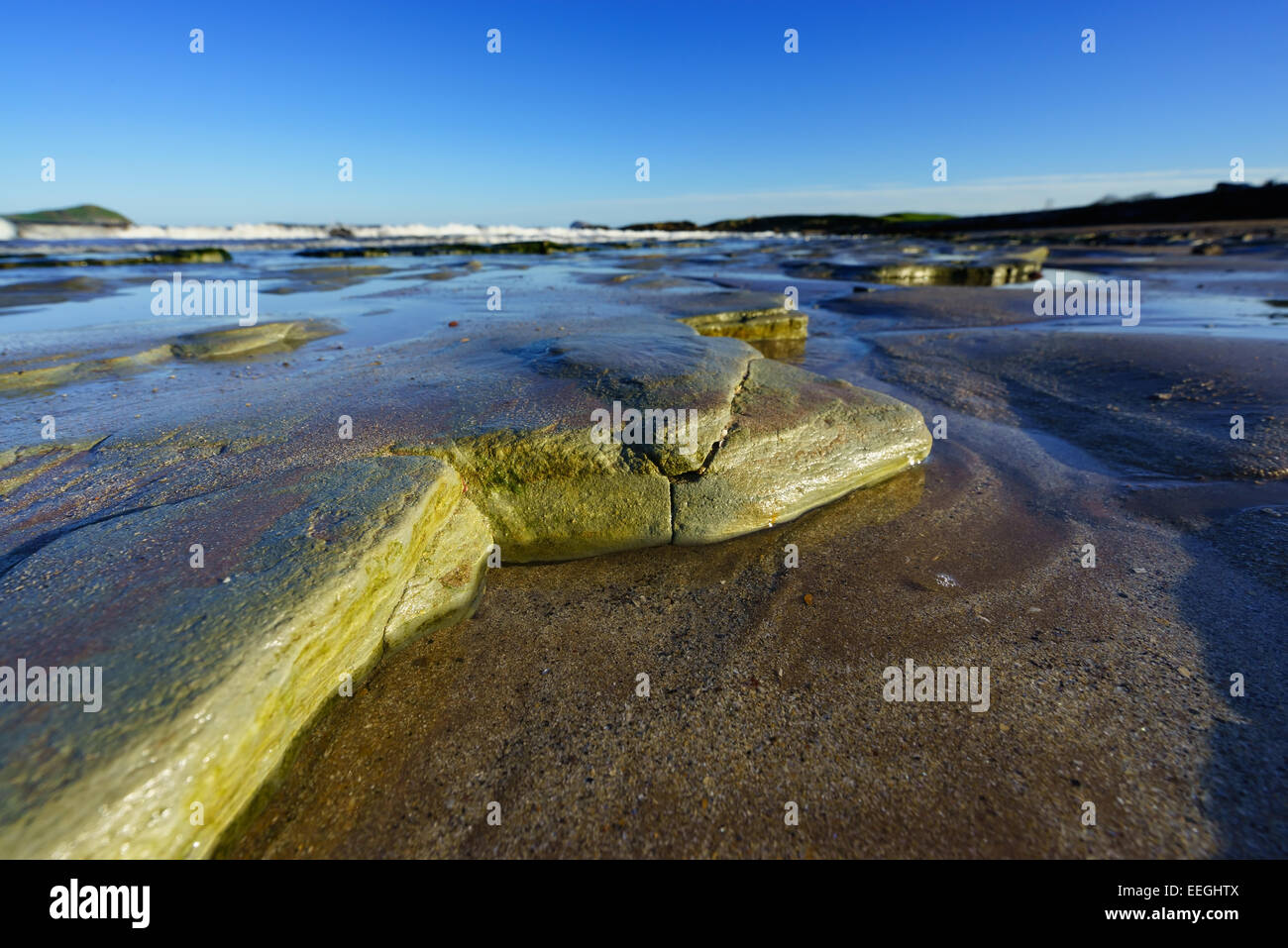Layered sandstone rocks on a beach in Scotland Stock Photo - Alamy