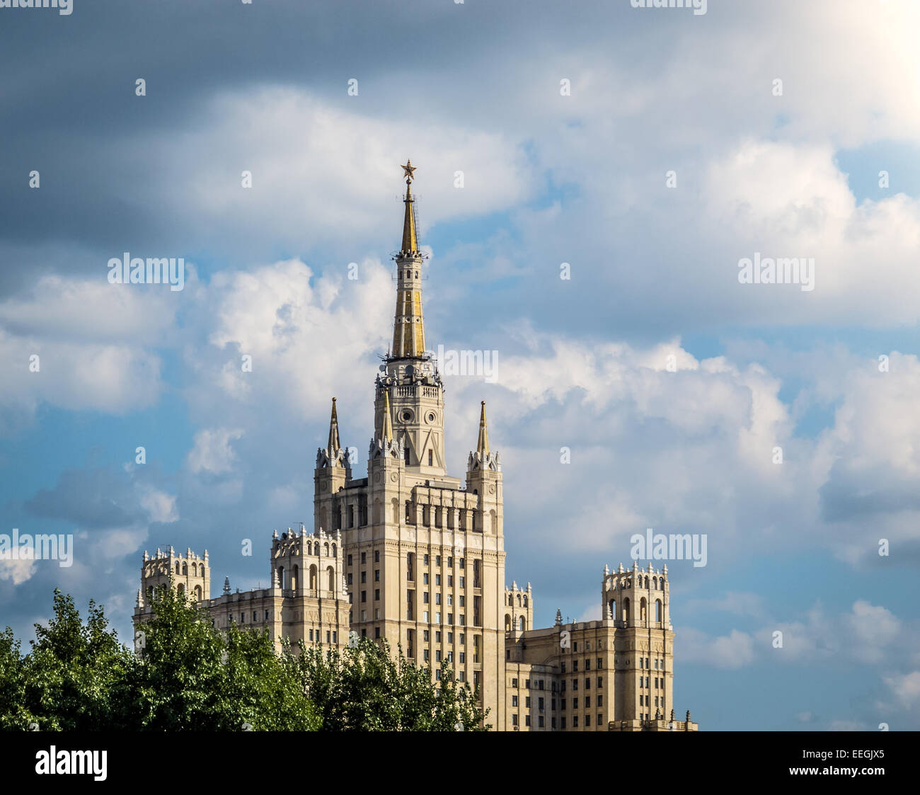 One of Moscow's famous highrises. Blue cloudy sky in background, tree ...