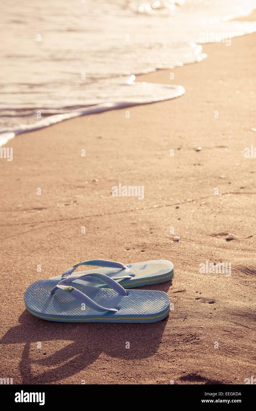 sandals, flip-flops the perfect beach shoe near the waves on the ...