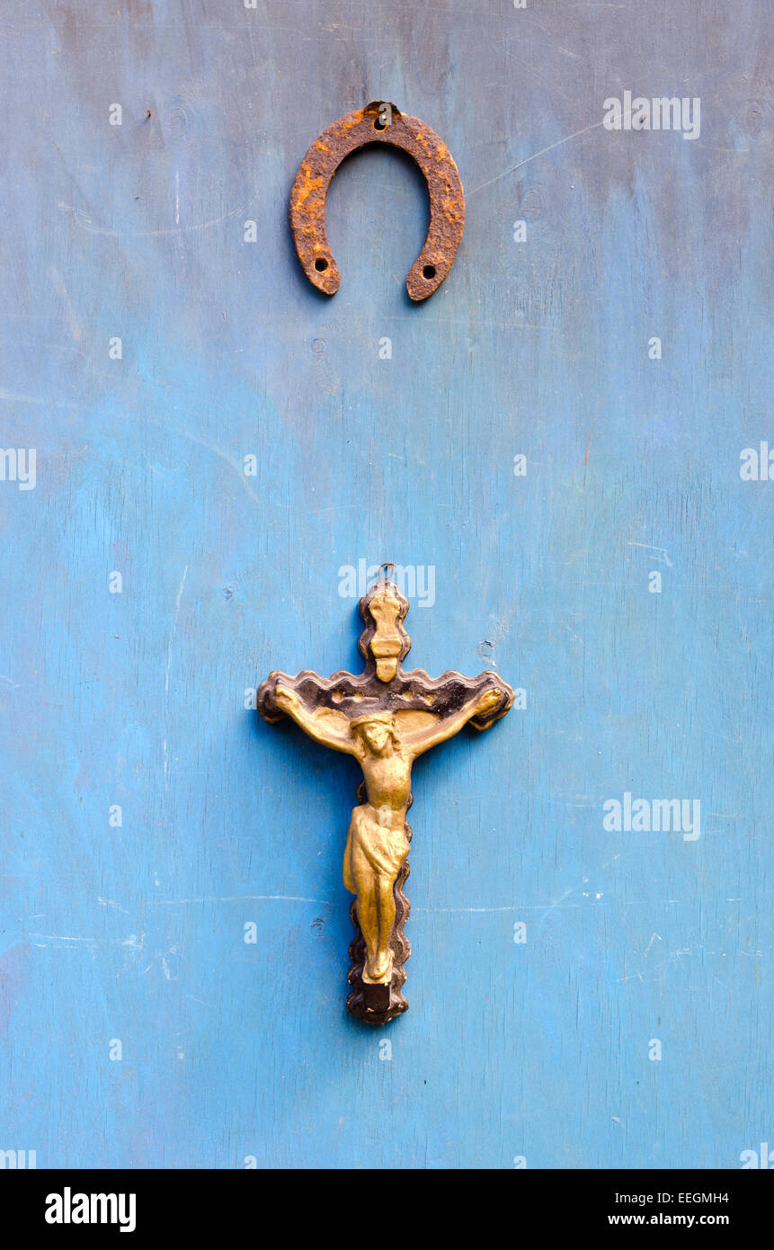Suffering of Jesus Christ crucifixion and rusty horseshoe on old blue ...