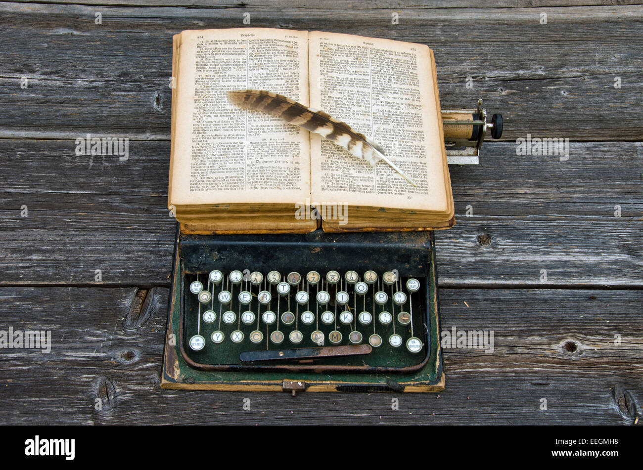 antique typewriter with old book Bible and bird feather on used ...