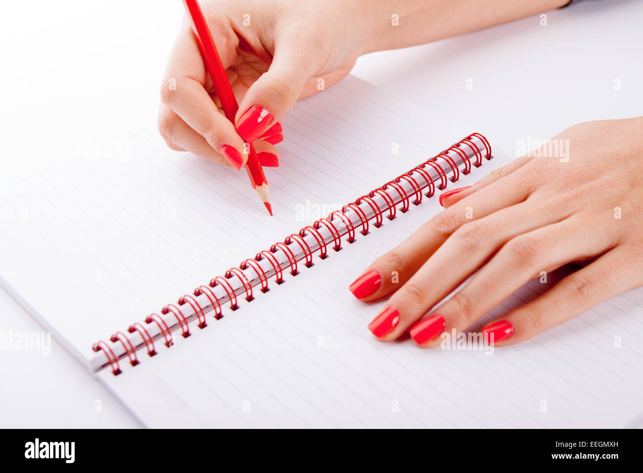 Woman writing with wooden pencil on white sheet Stock Photo - Alamy