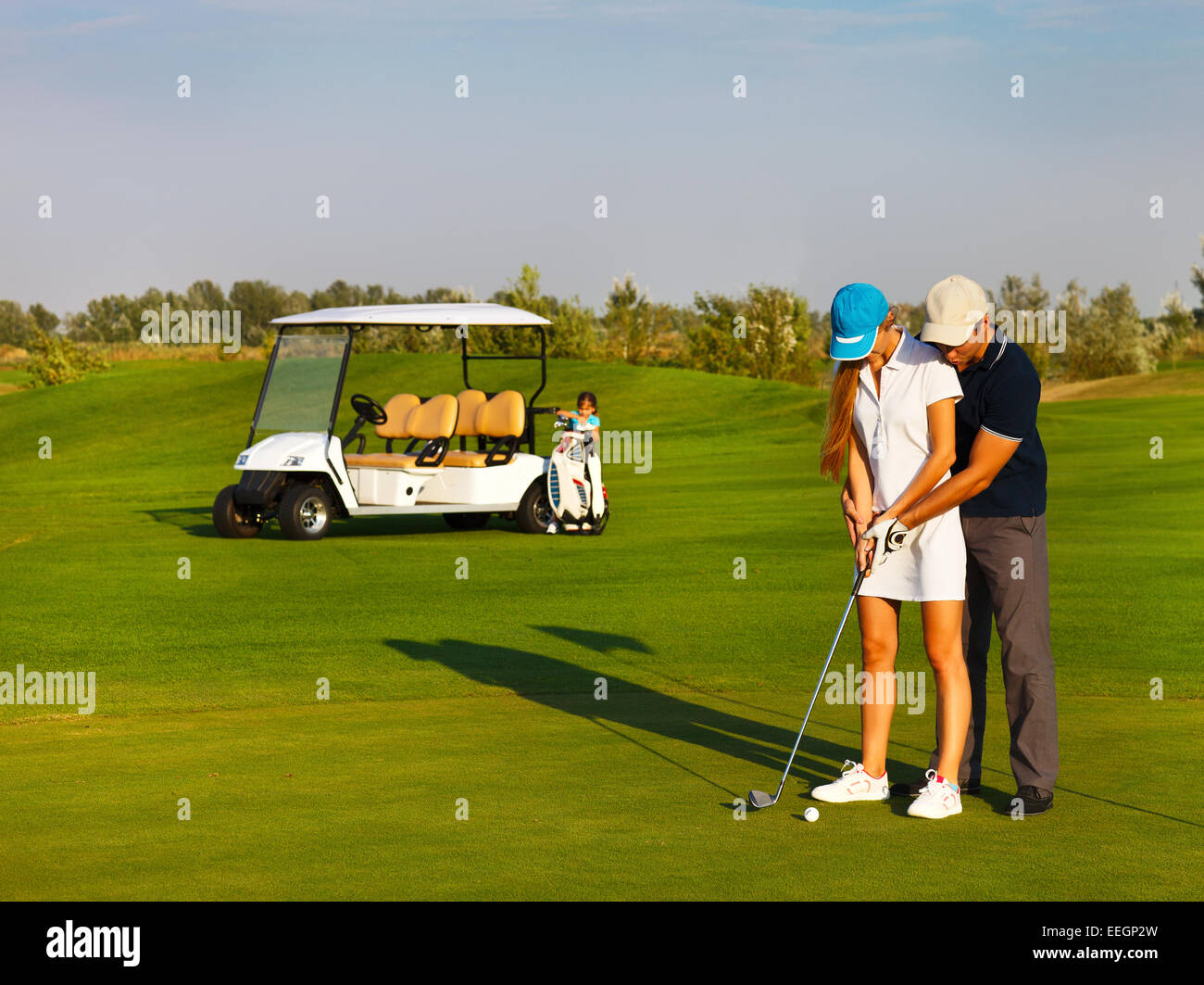 Sportive happy family playing golf on a golf course Stock Photo - Alamy