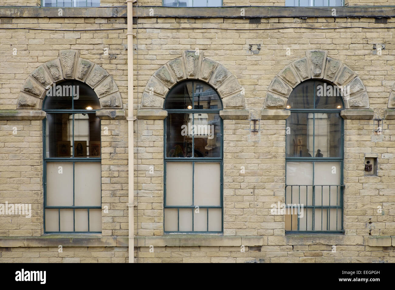 Ornate arched windows in the Victorian mill at Saltaire, Yorkshire, UK ...
