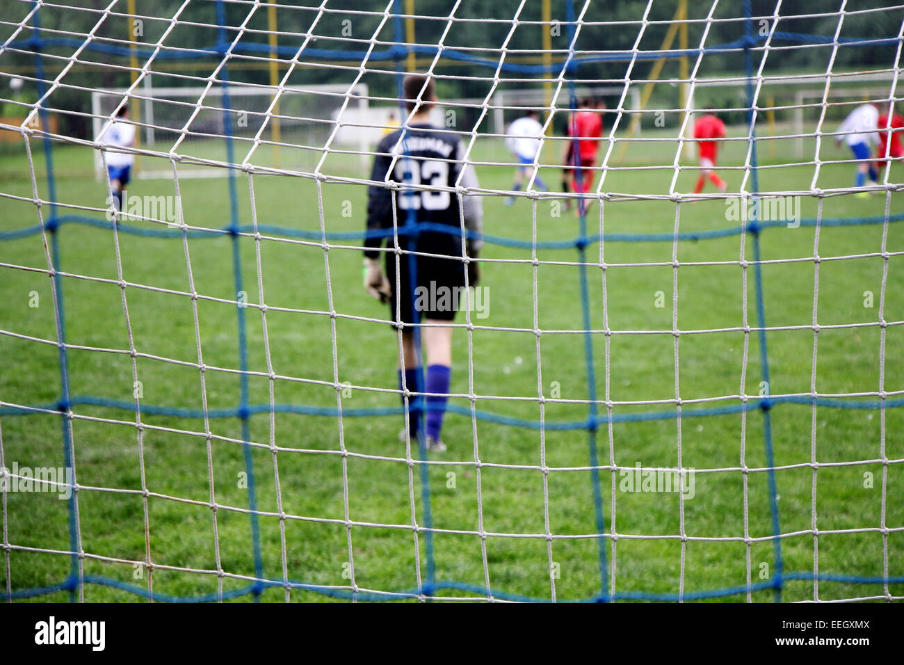 Soccer goal mesh with football players in action background soft focus ...