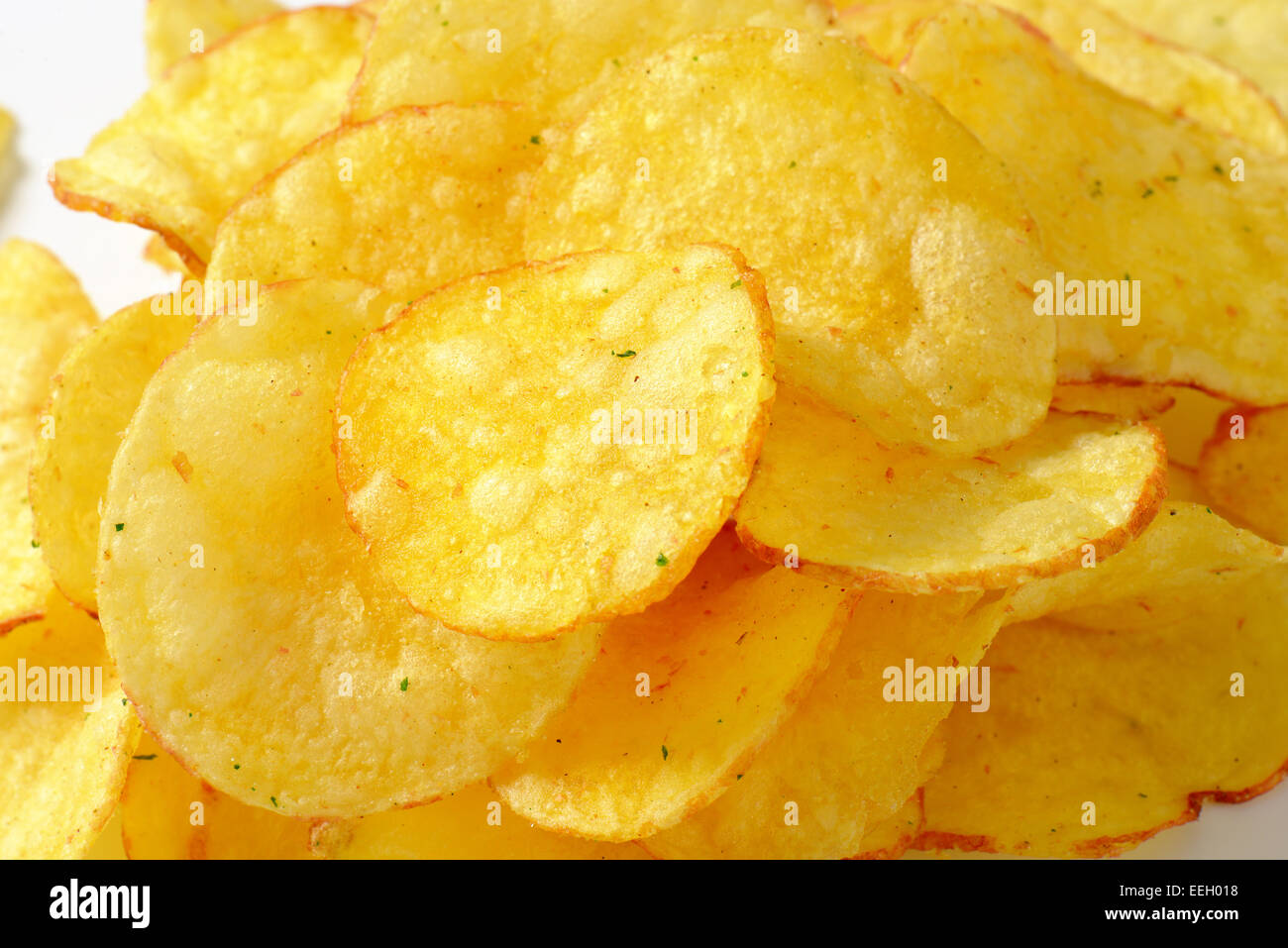 Heap of potato chips on white background Stock Photo - Alamy