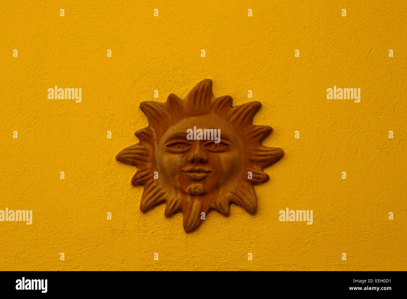 Sun symbol on a house wall Stock Photo - Alamy
