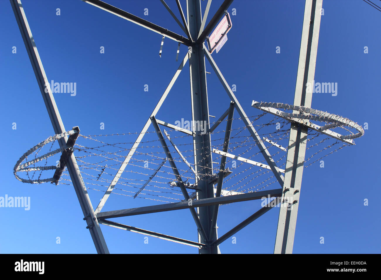 Barbed Wire Power Pylon and Blue Sky Stock Photo - Alamy