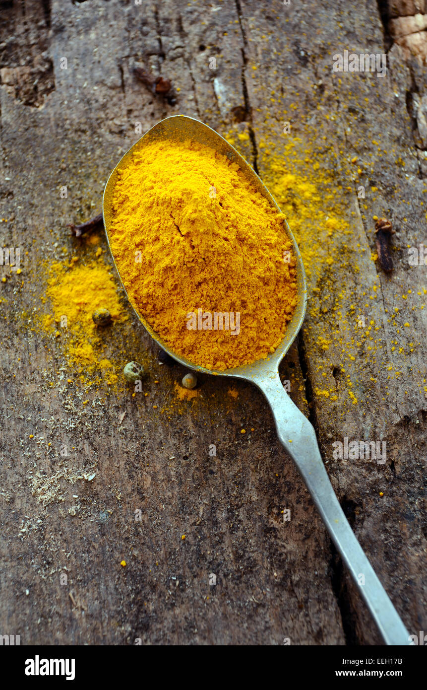 Ground turmeric in a spoon Stock Photo - Alamy