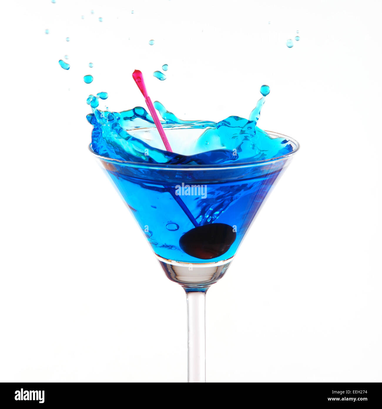 blue cocktail splashing on white background Stock Photo - Alamy