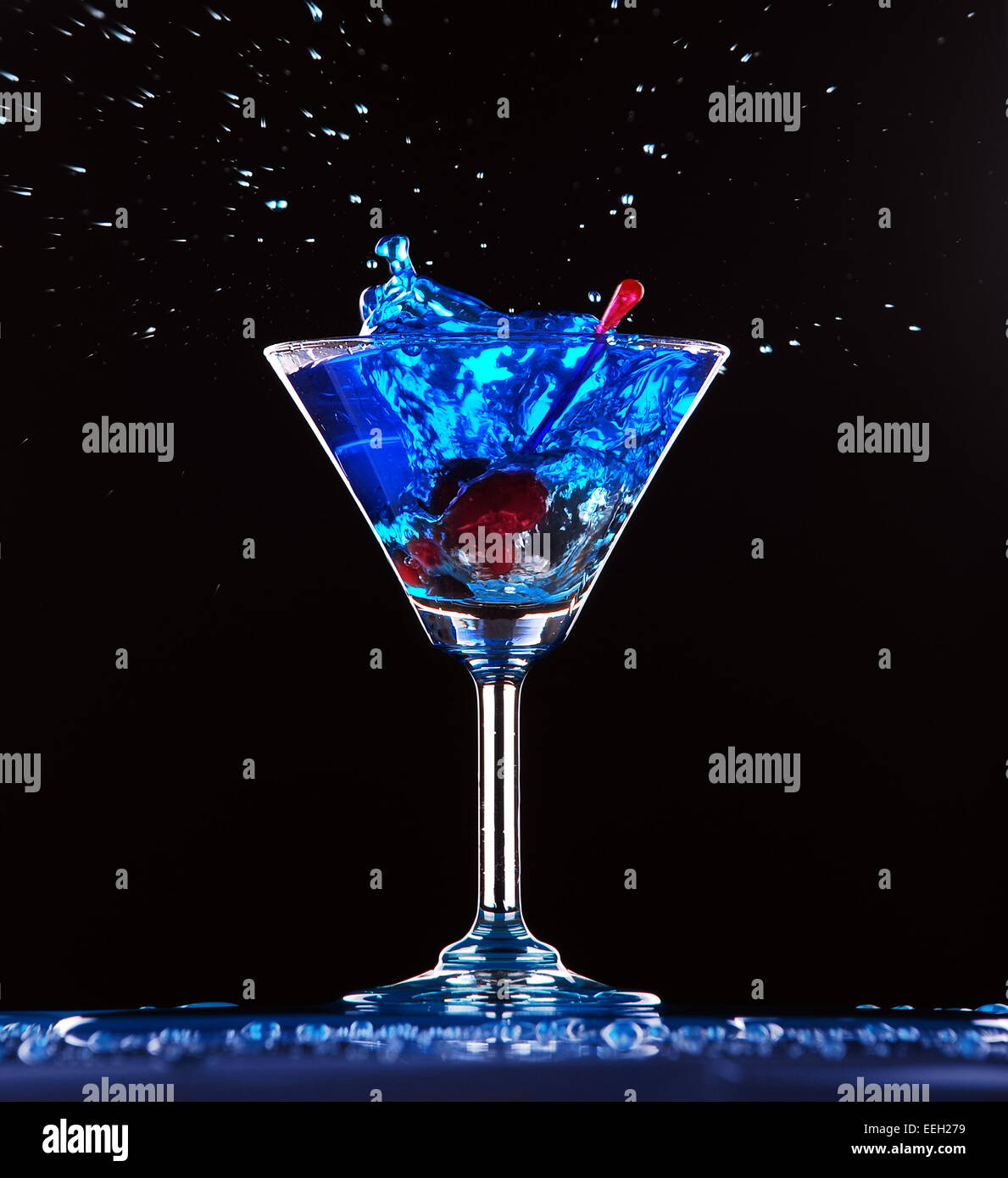 blue cocktail splashing on dark background Stock Photo - Alamy