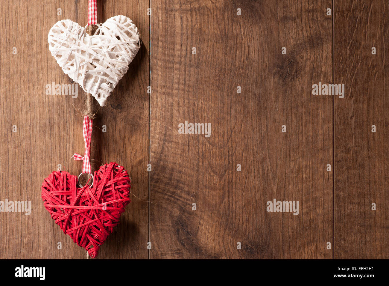Hearts hanging on wooden wall Stock Photo - Alamy