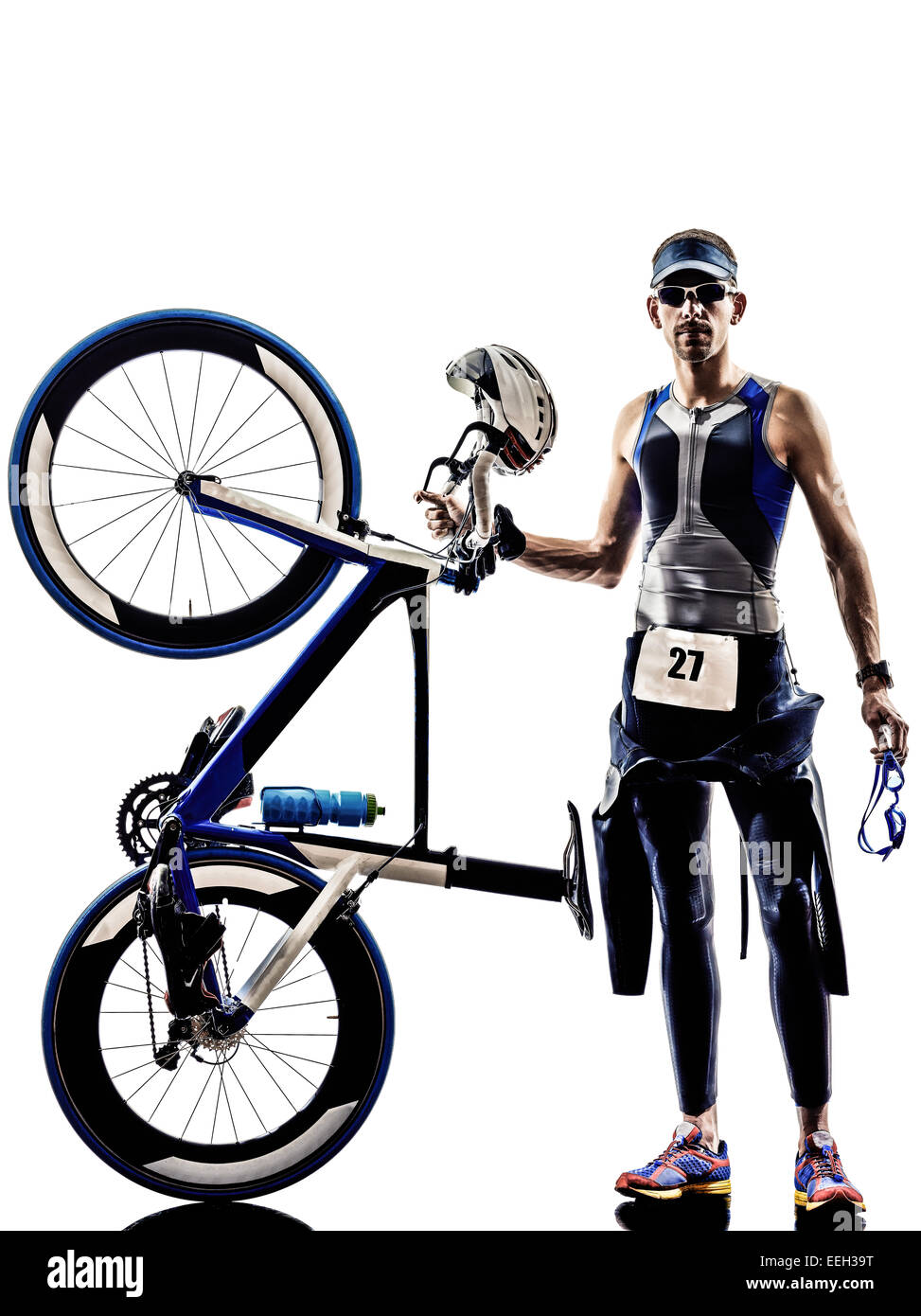 man triathlon iron man athlete standing with all his equipment in ...