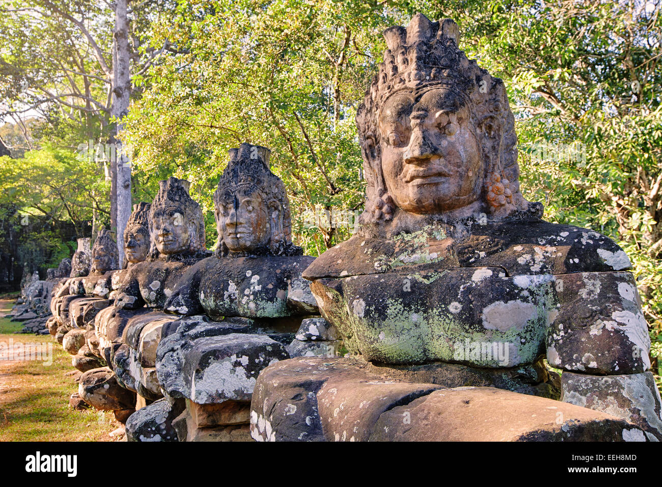 Bayon temple stone carvings along the bridge Stock Photo - Alamy