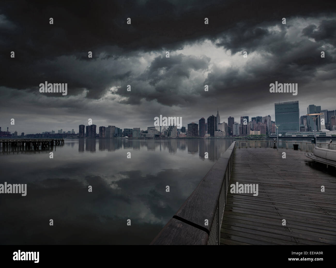 Manhattan New York cloudy dramatic skyline sunset from East River dusk ...