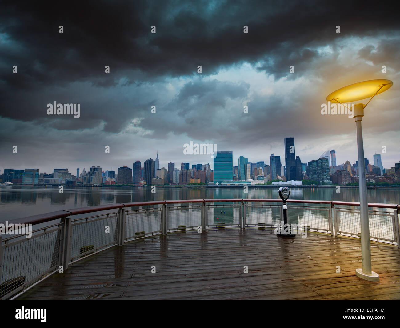 Manhattan New York cloudy dramatic skyline sunset from East River dusk ...