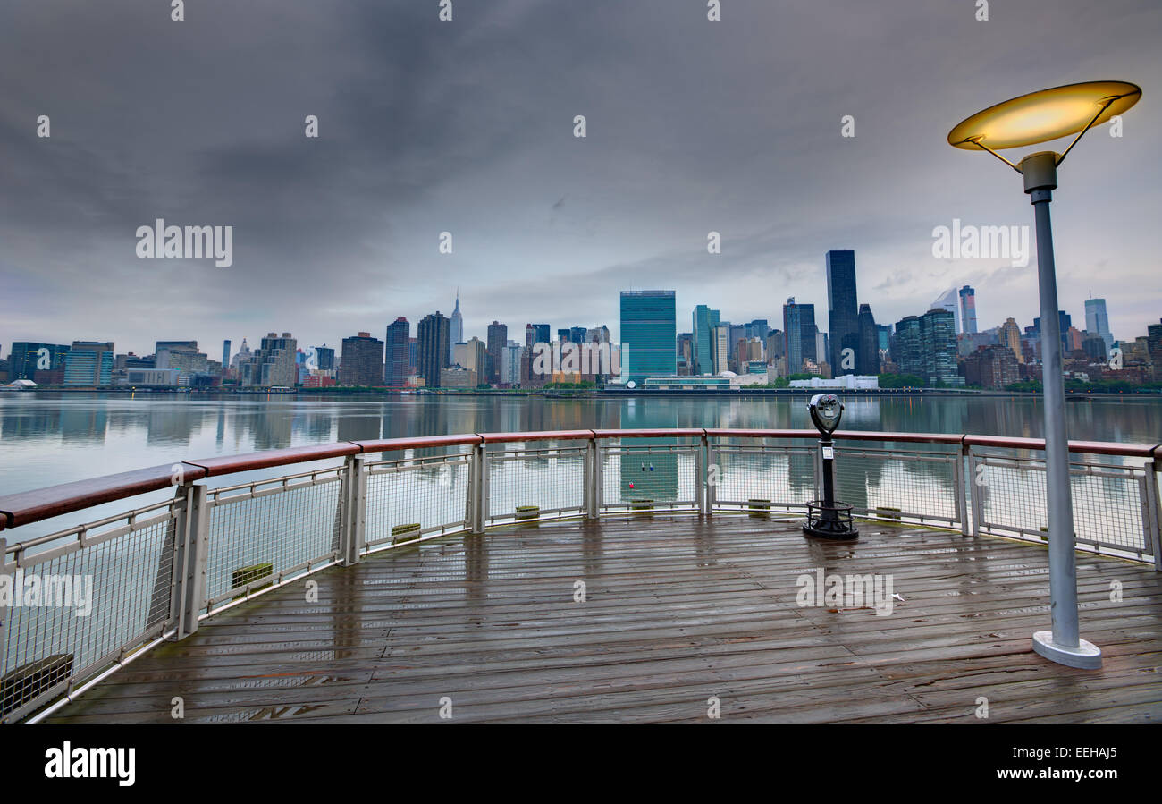 Manhattan New York cloudy dramatic skyline sunset from East River dusk ...