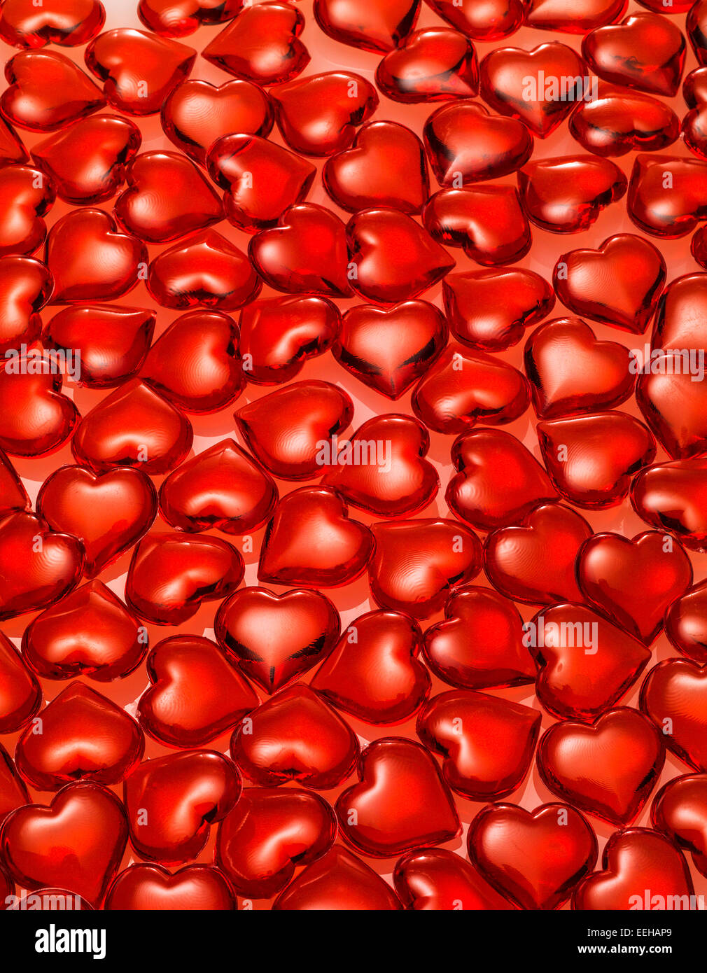 A beautiful random collection of red hearts on a red background close ...