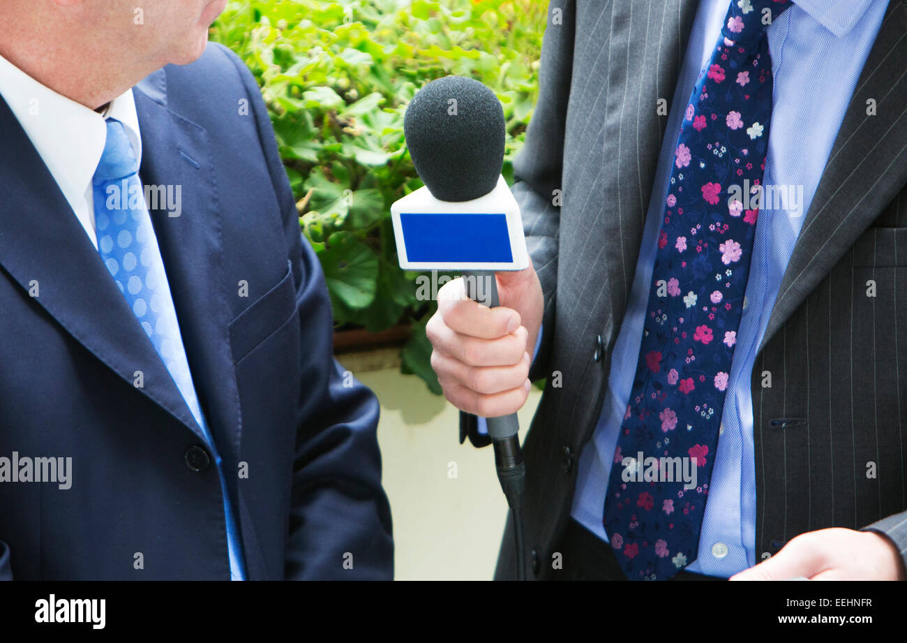 Man Being Interviewed By Journalist For TV Or Radio Stock Photo - Alamy