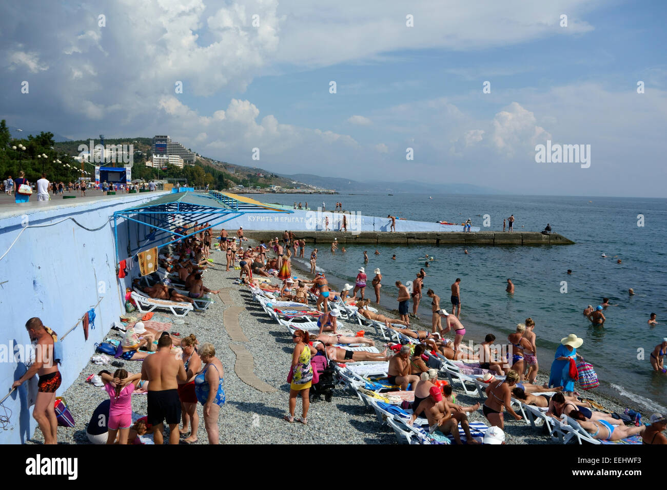Ukrainian refugees and Russian tourists on a crowded public beach in ...